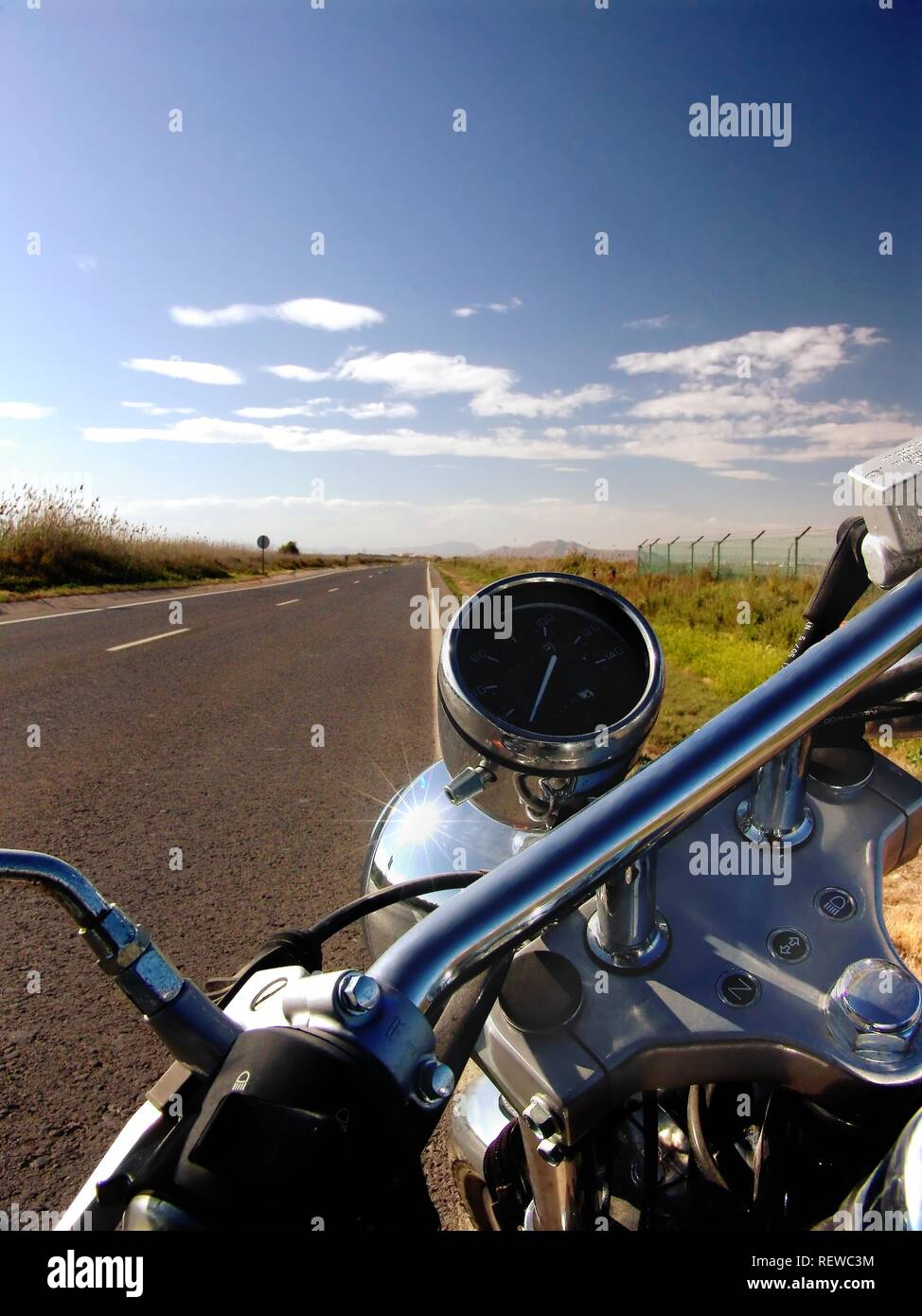 Rider's view from parked motorcycle parked at a roadside on a warm ...