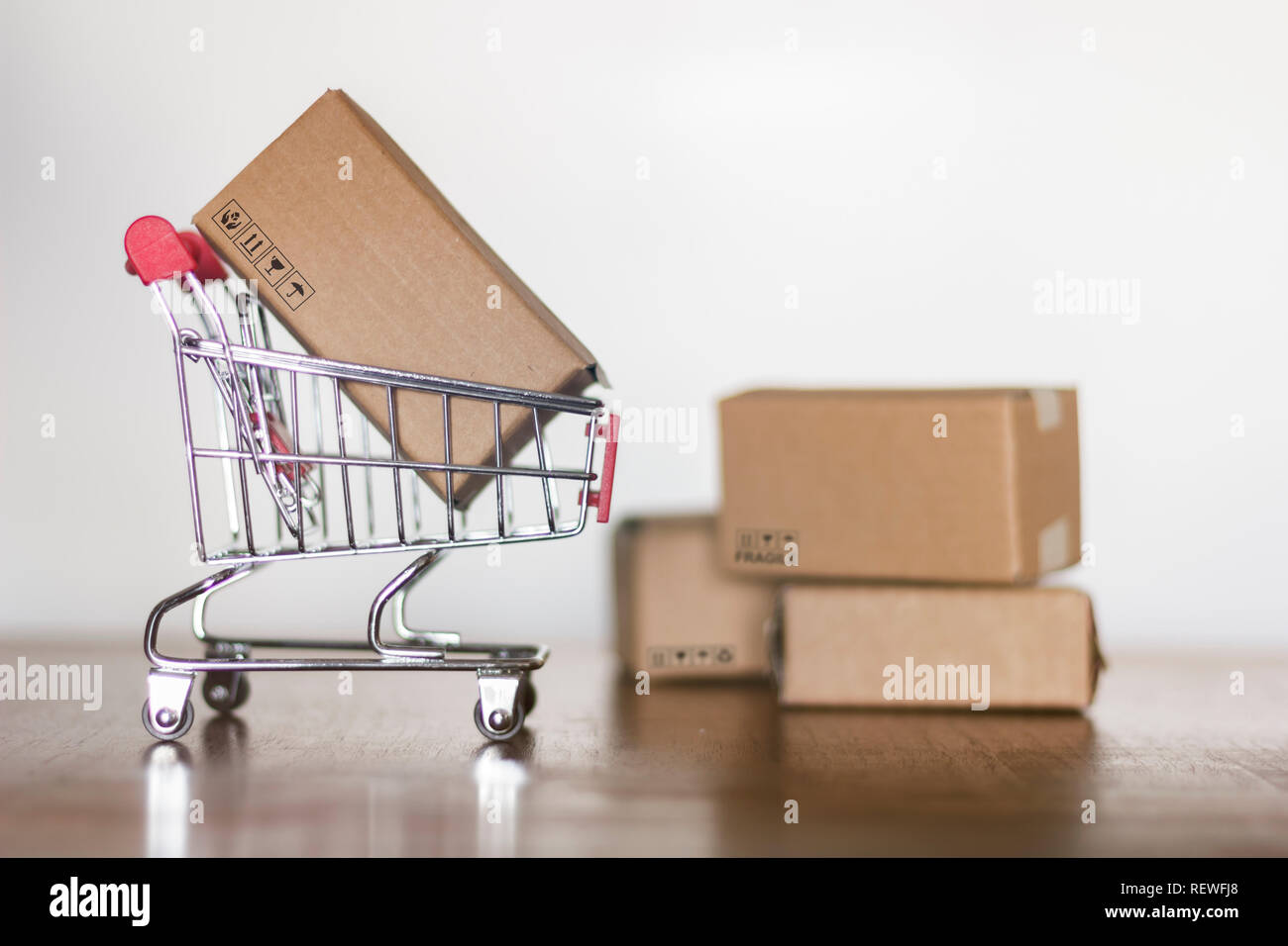 Cartons and trolley. Shopping concept Stock Photo - Alamy