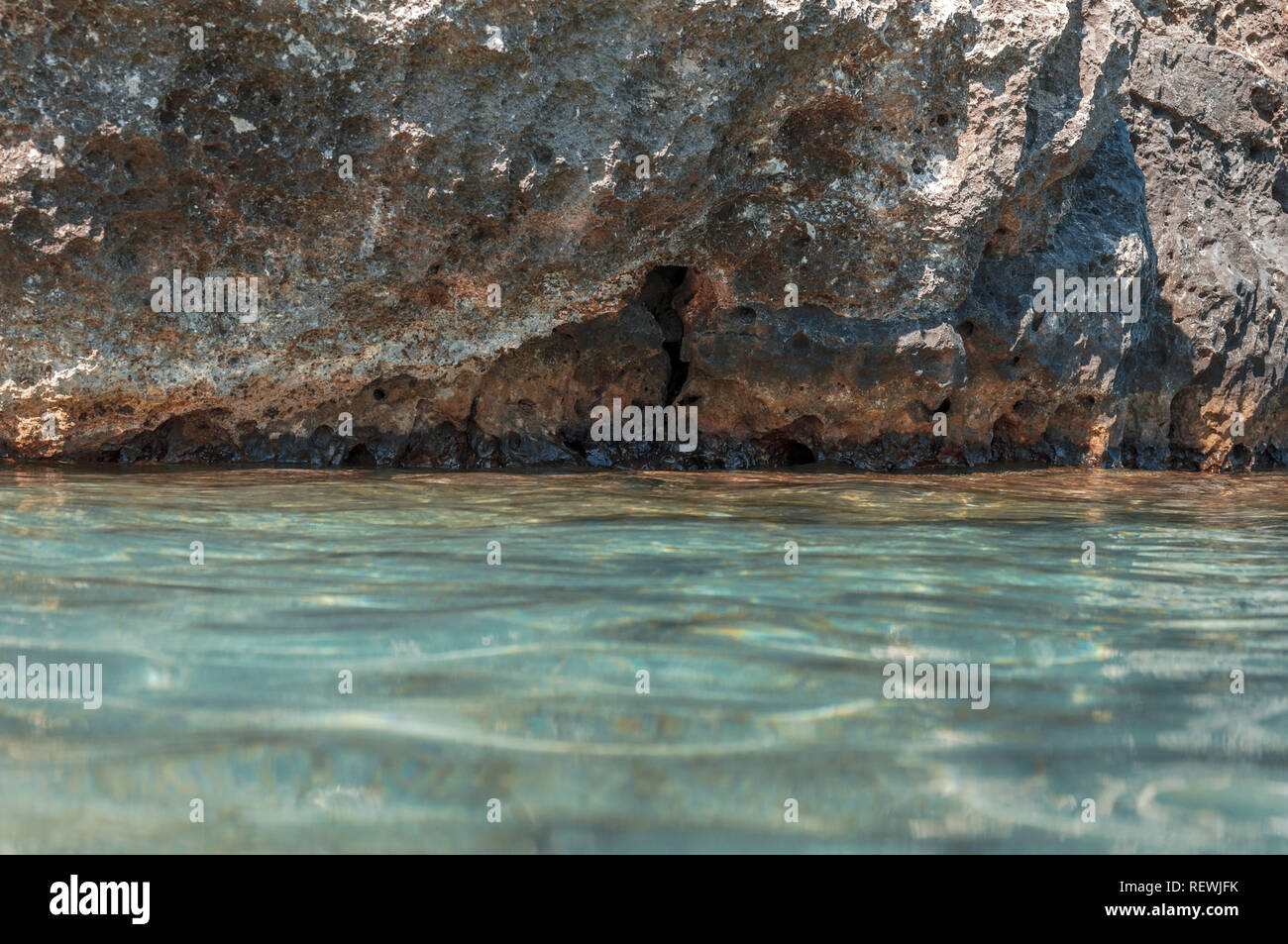 Stone rock cliff with sea foreground Stock Photo - Alamy