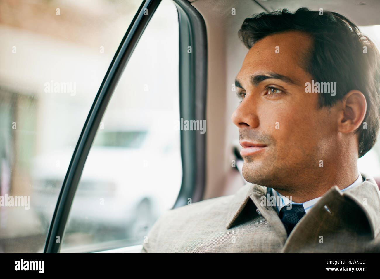 Thoughtful businessman looks out of a taxi window Stock Photo - Alamy Thoughtful businessman looks out of a taxi window Stock Photo - Alamy