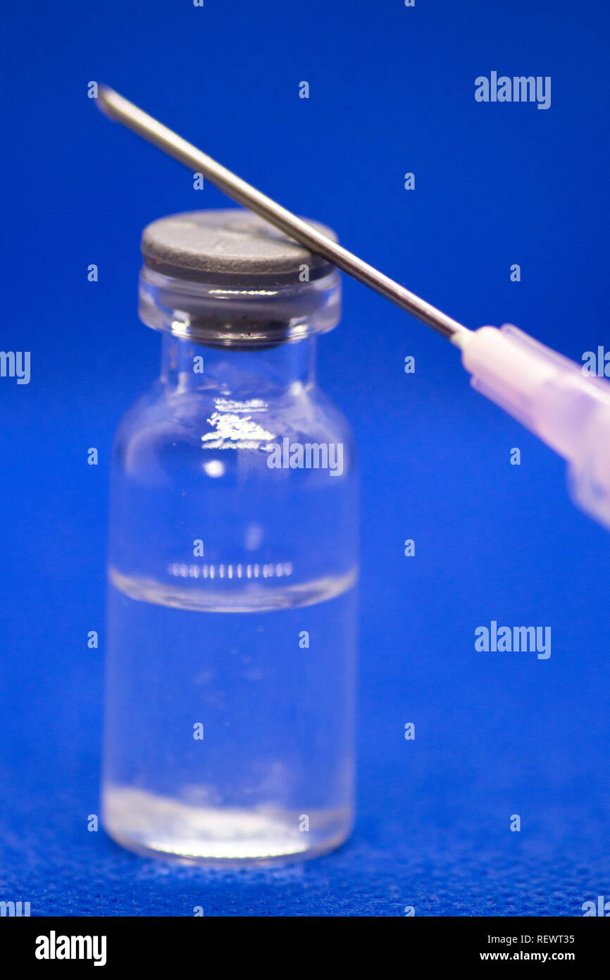 Medicine and drug concept. Medical ampoules, syringe and injection on ...