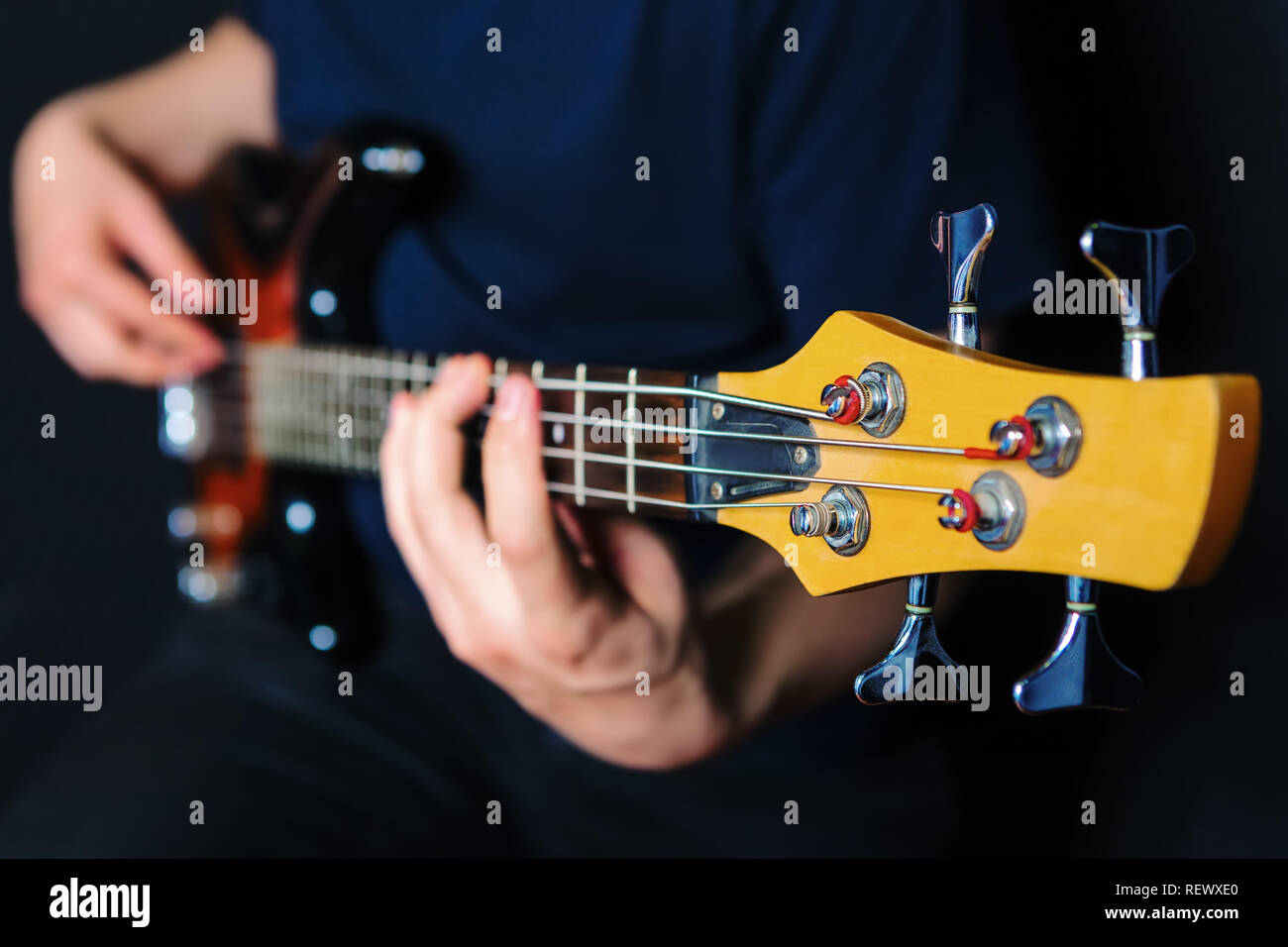 Young musician playing bass guitar hi-res stock photography and images ...