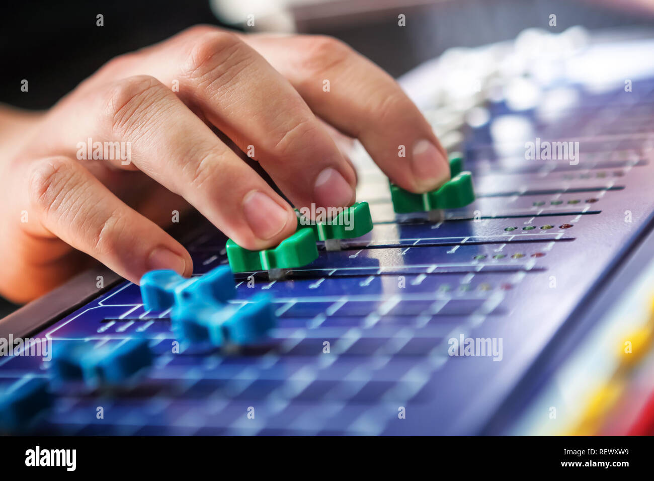 Professional audio engineer adjusting mixing concole Stock Photo - Alamy