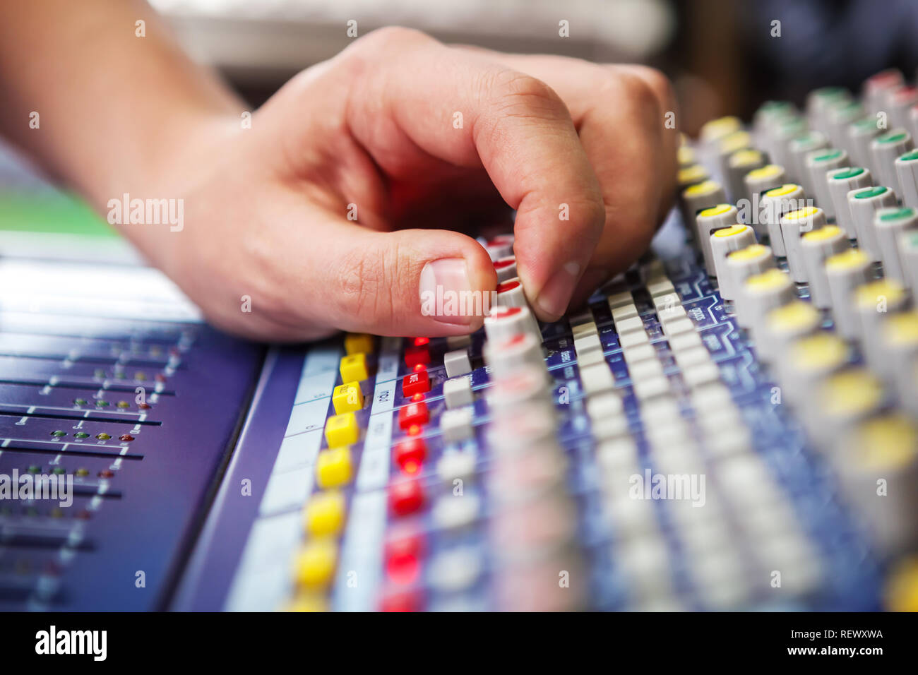 Professional audio engineer adjusting mixing concole Stock Photo - Alamy