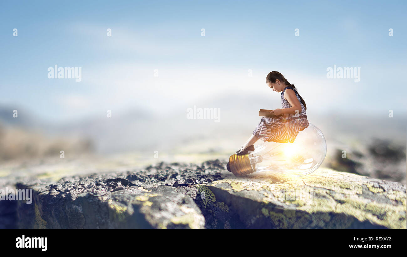 School Girl Sitting On Glass Glowing Bulb And Reading Book Mixed Media