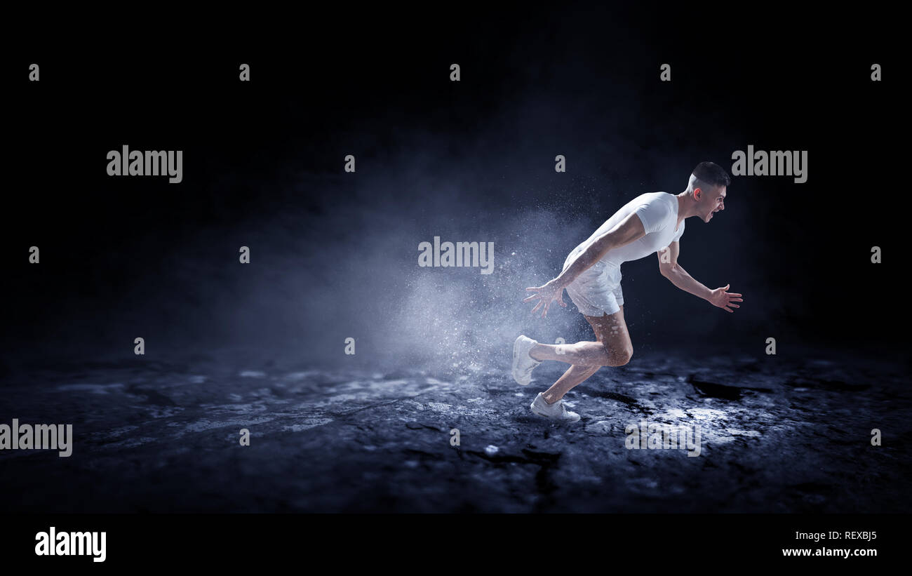 Young athlete running running outdoor in darkness. Mixed media Stock ...