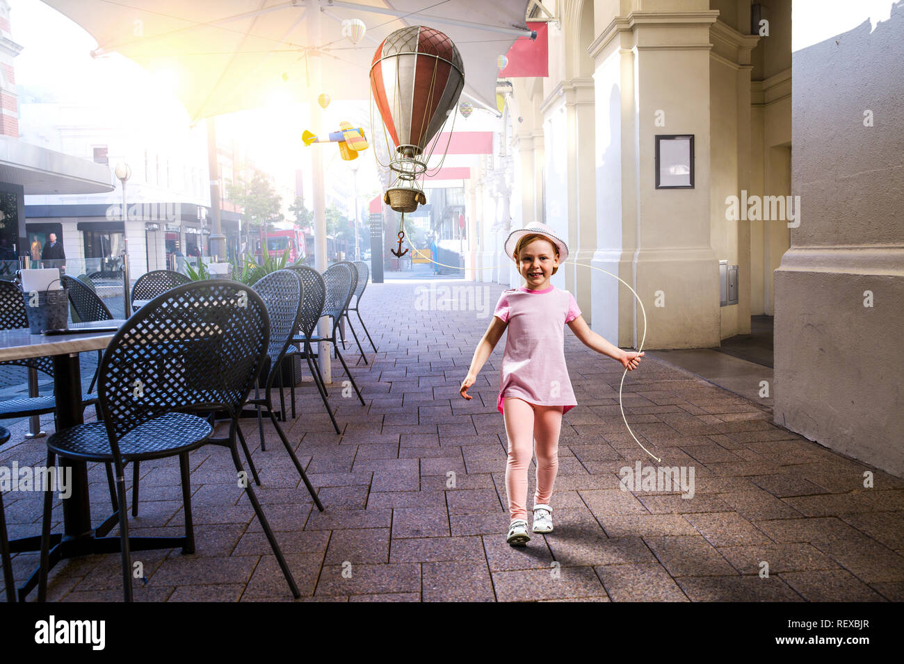Little kid girl with aerostat balloon walking alone. Mixed media Stock ...