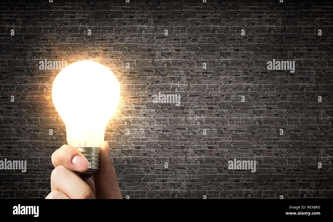 Glowing light bulb in hand as symbol for bright idea Stock Photo - Alamy