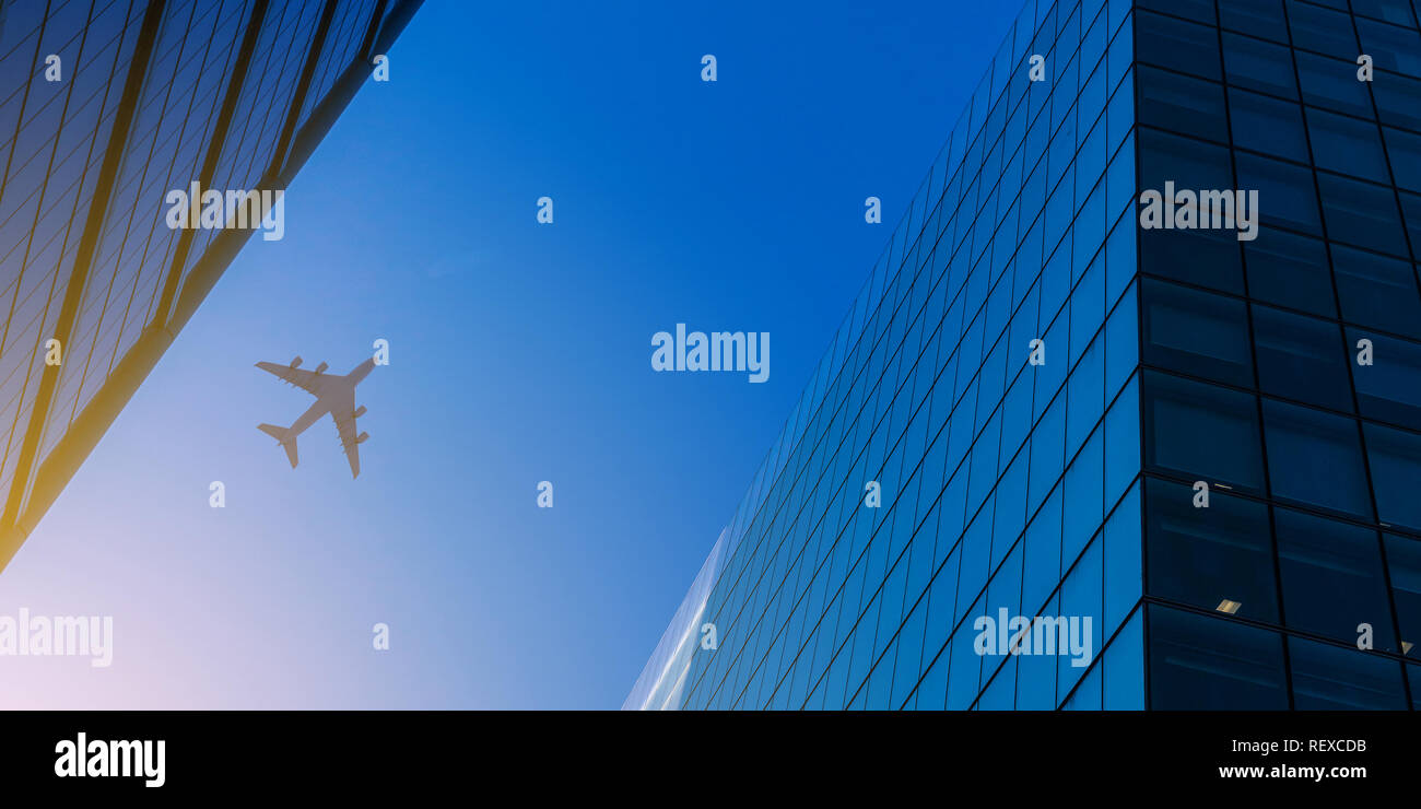 Bottom angle view of airplane in sky over city buildings Stock Photo ...