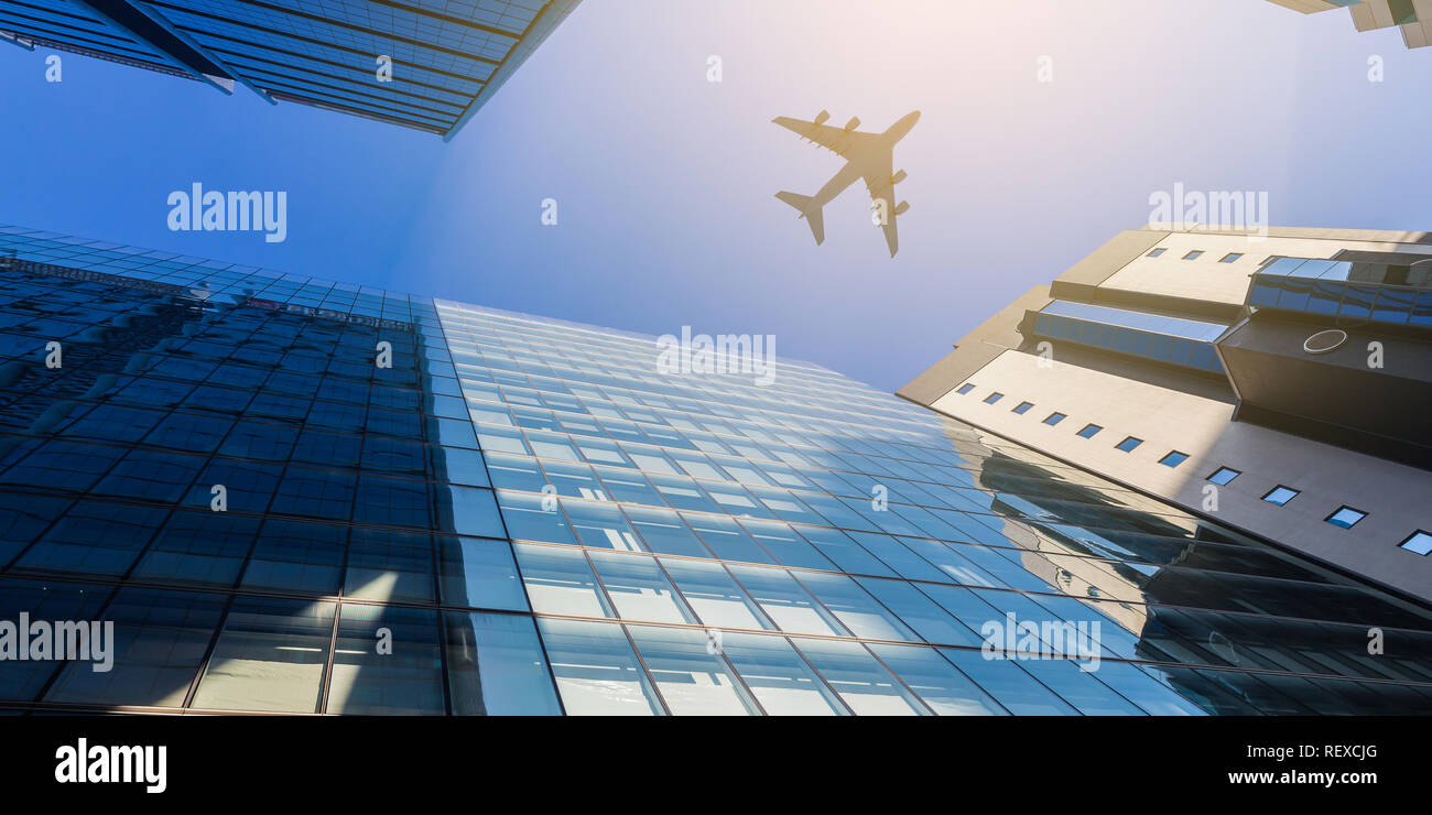 Bottom angle view of airplane in sky over city buildings Stock Photo ...