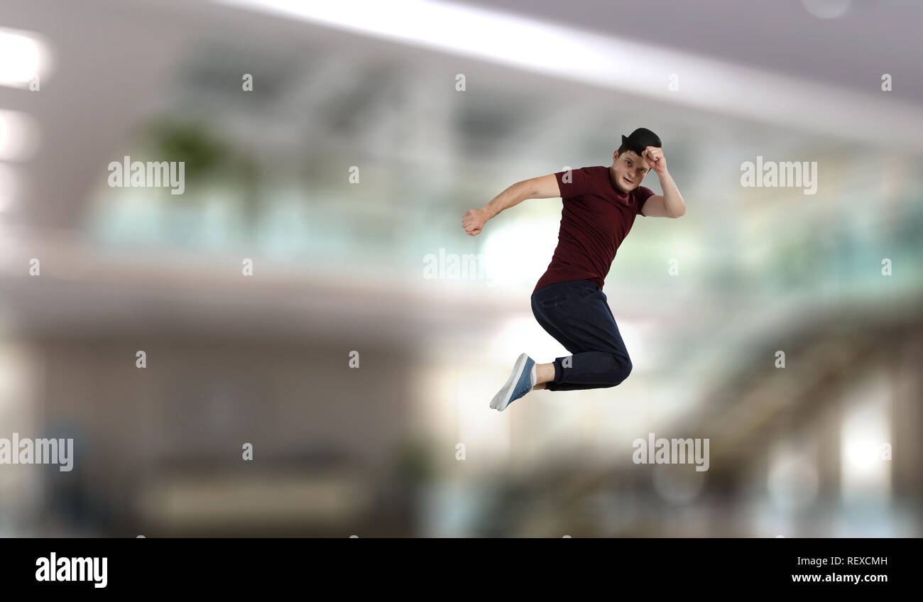 Young male professional dancer in hat jumping high. Mixed media Stock ...