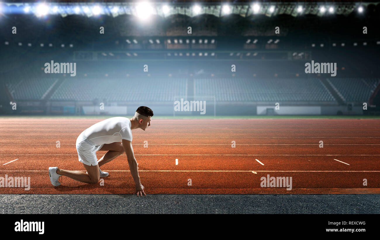 Athlete man running on racetrack at stadium. Mixed media Stock Photo ...