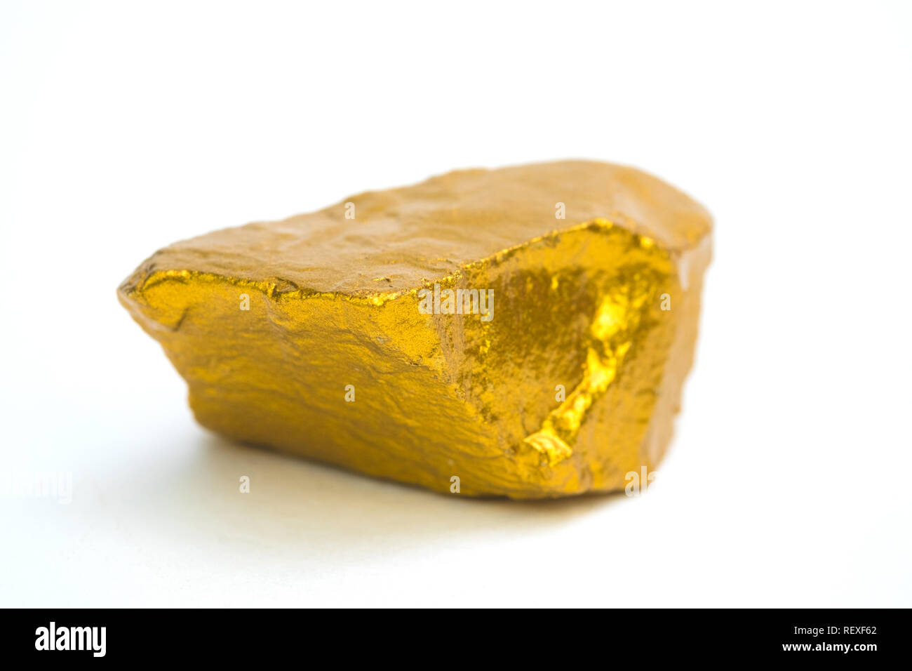Closeup of gold nugget or gold ore on white background, precious stone ...