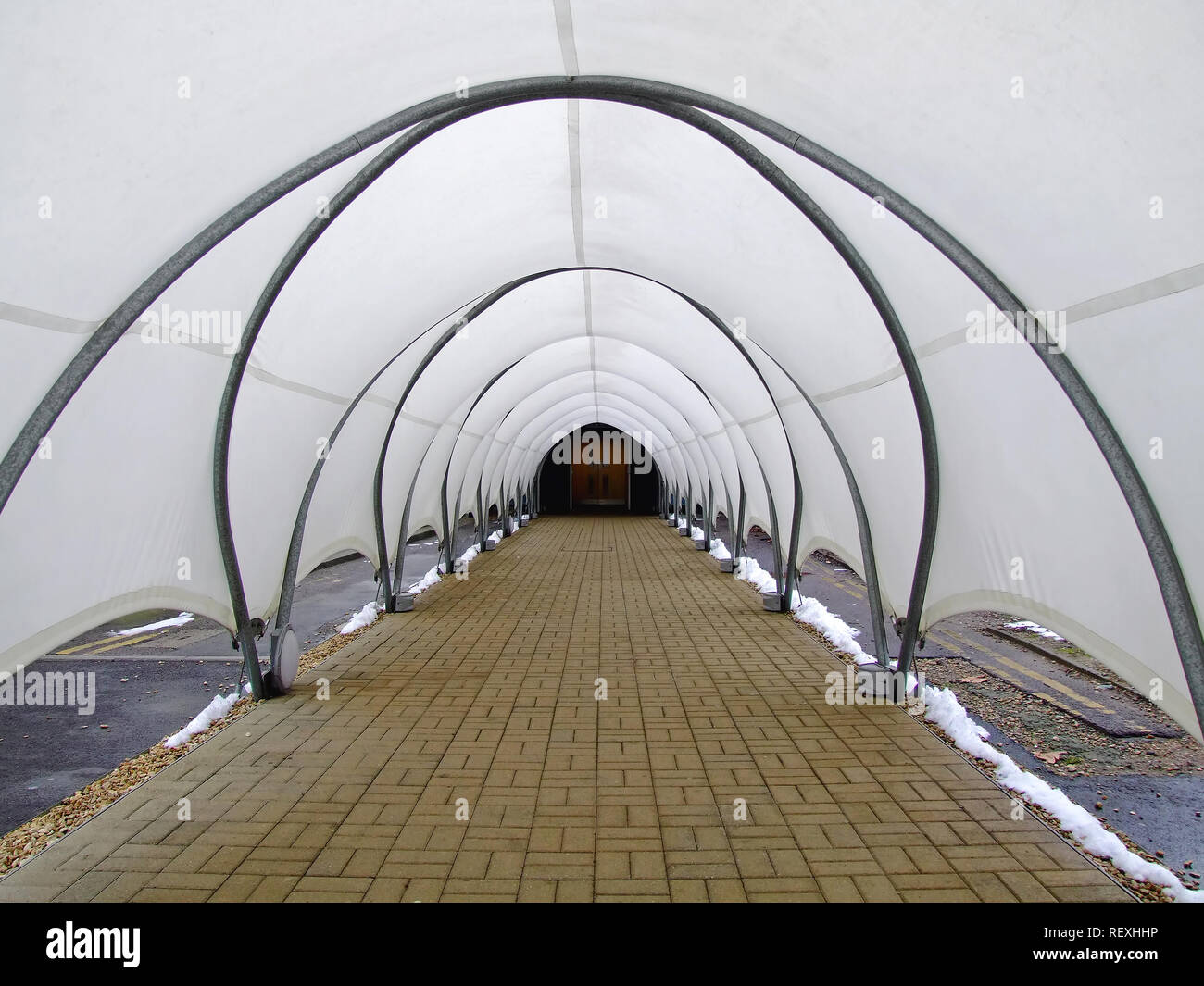 Long corridor with white canopy for protection Stock Photo - Alamy