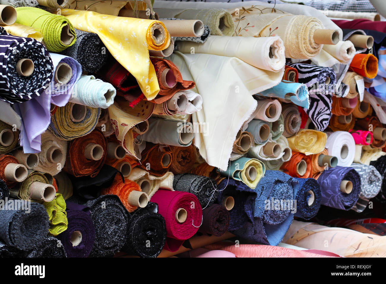 Fabric rolls in shelf for fashion industry Stock Photo - Alamy