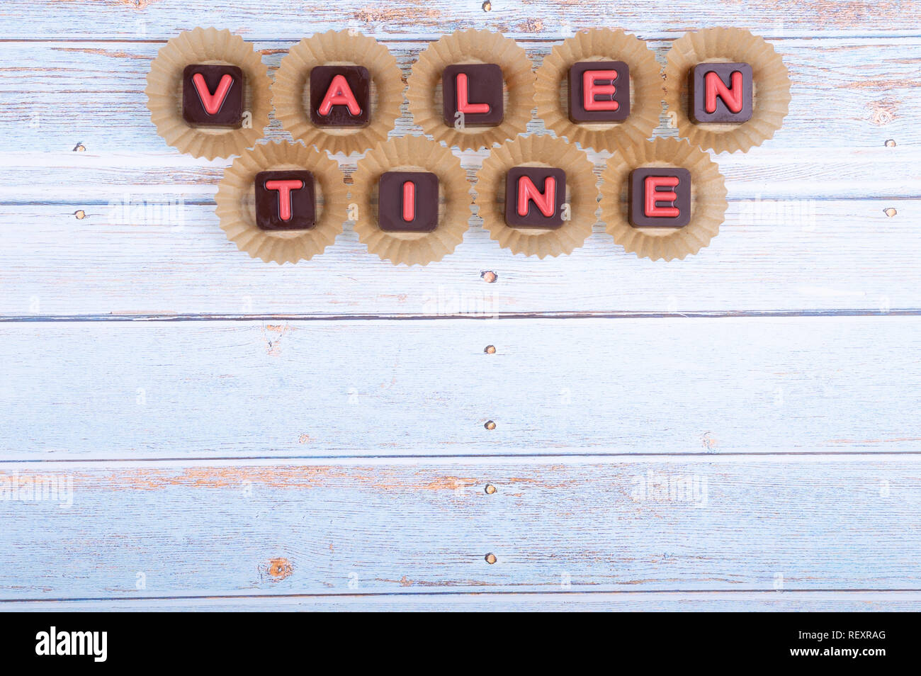 Valentine engraved in chocolate on colored background Stock Photo - Alamy