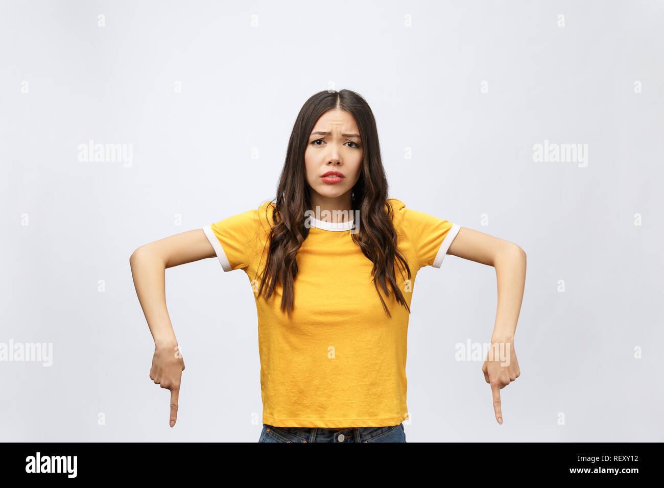 young attractive asian woman who points to the finger with unhappy ...