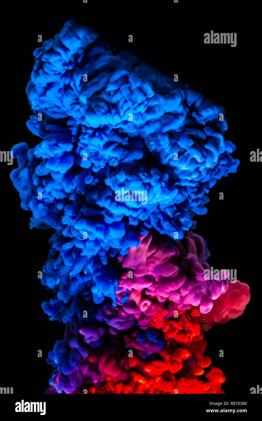 Blue and red color ink dissolving in water Stock Photo - Alamy