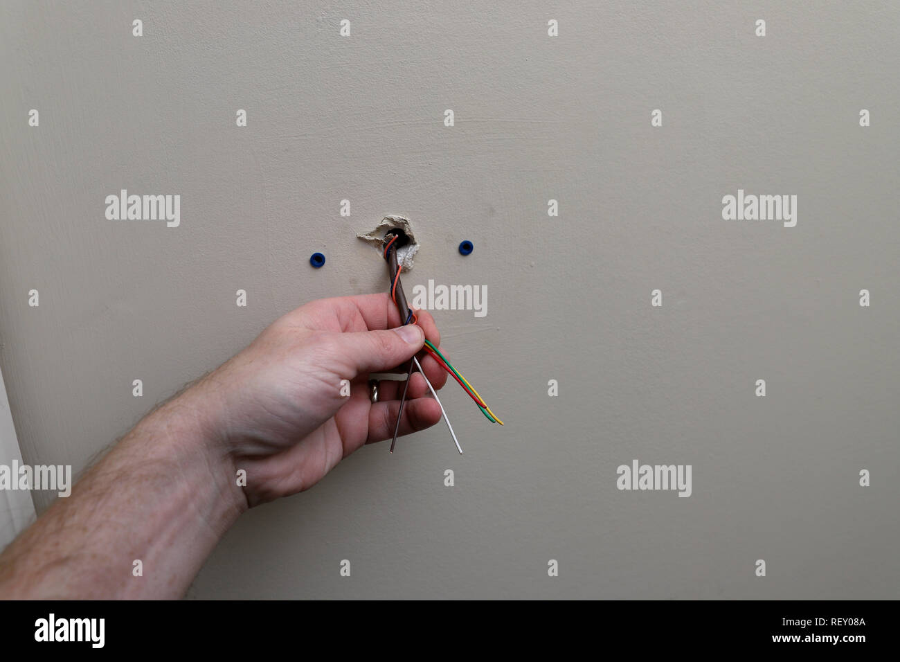 hand holding Control wire for thermsotat used with a HVAC unit, coming ...