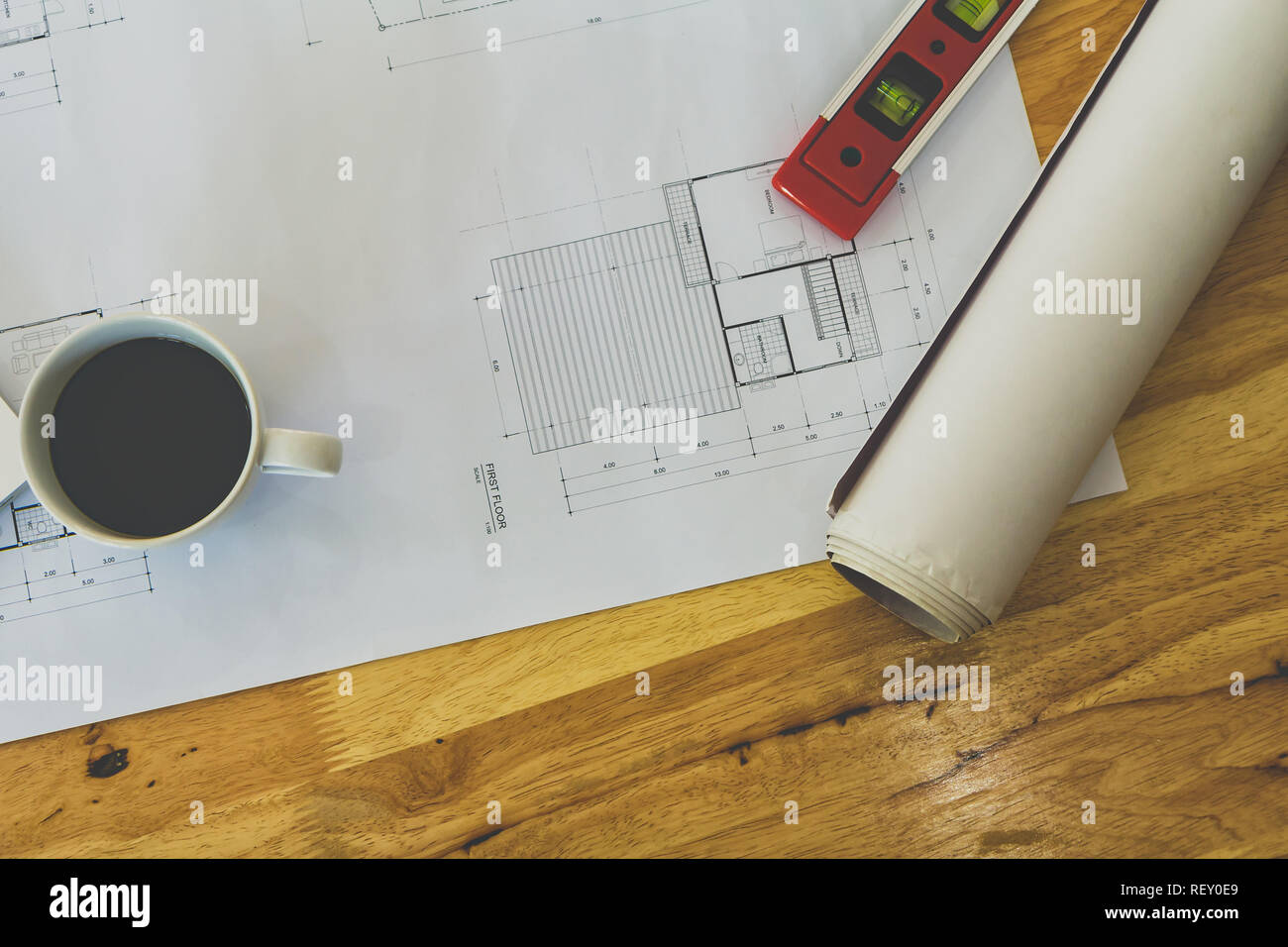 Blueprint and measurement tool and a cup of coffee on wooden desk Stock ...