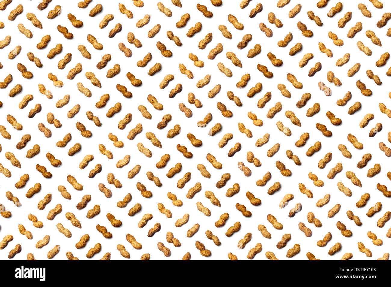 A collection of Unpeeled peanuts lie in straight rows along dioganals ...