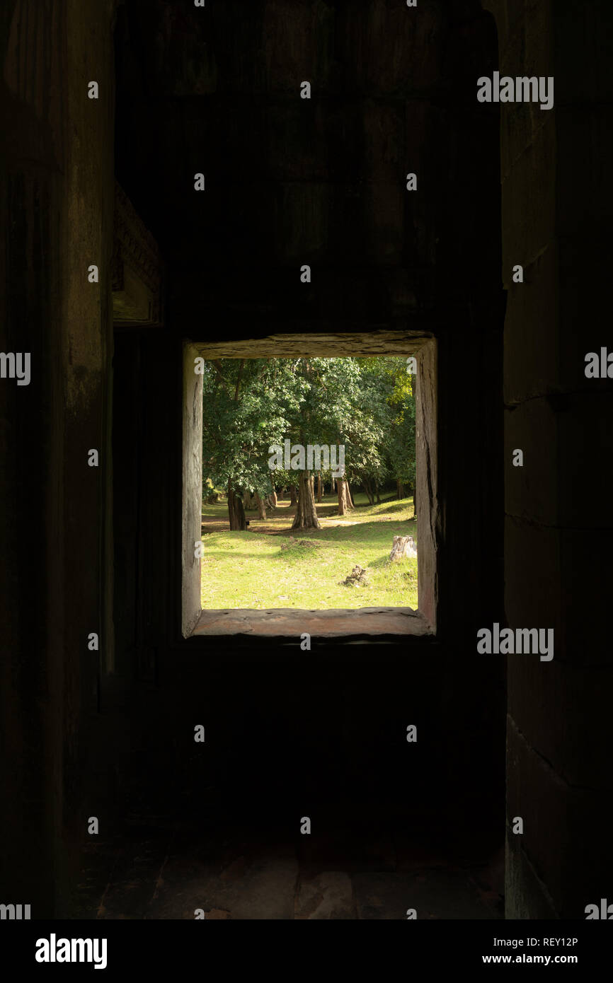 Trees seen through stone window in temple Stock Photo - Alamy
