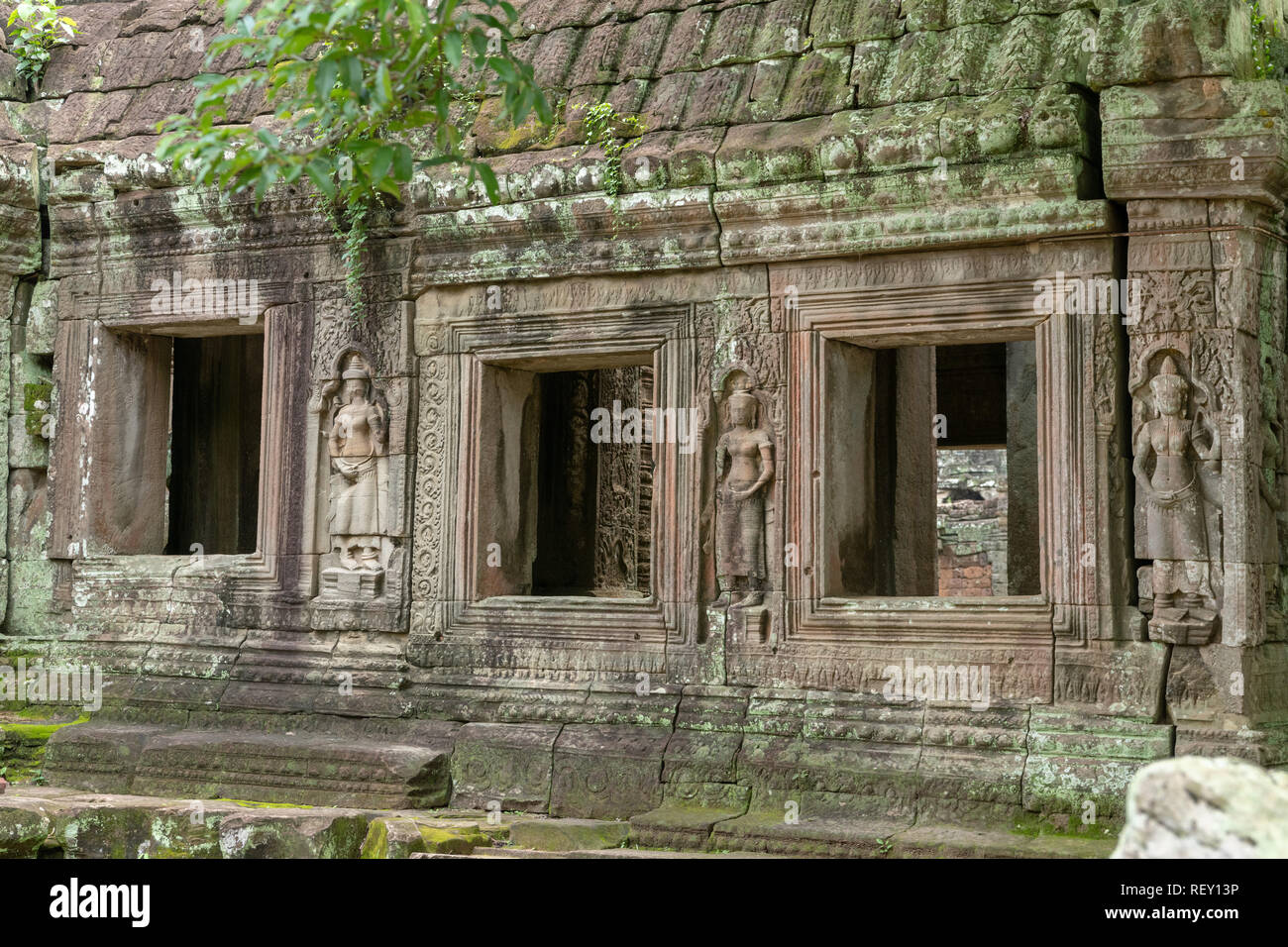Three temple windows decorated with stone statues Stock Photo - Alamy