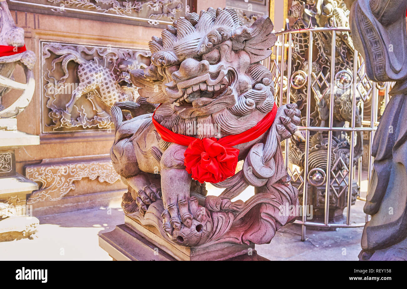 The scenic carved stone statue of Chinese Guardian Lion, also named Foo ...