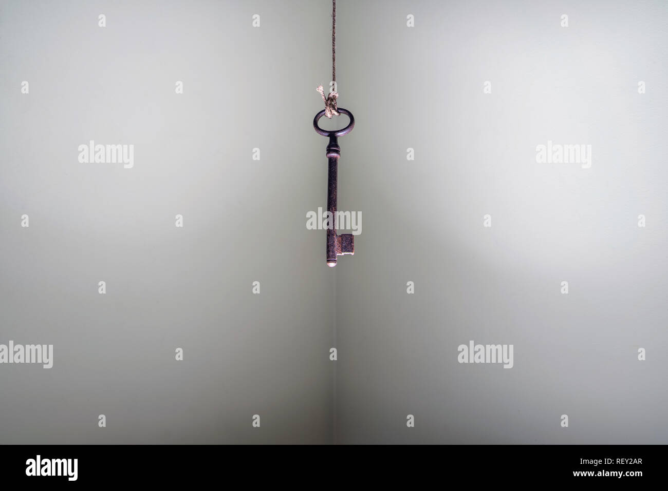 Looking up at old key hanging on string. Business success freedom ...