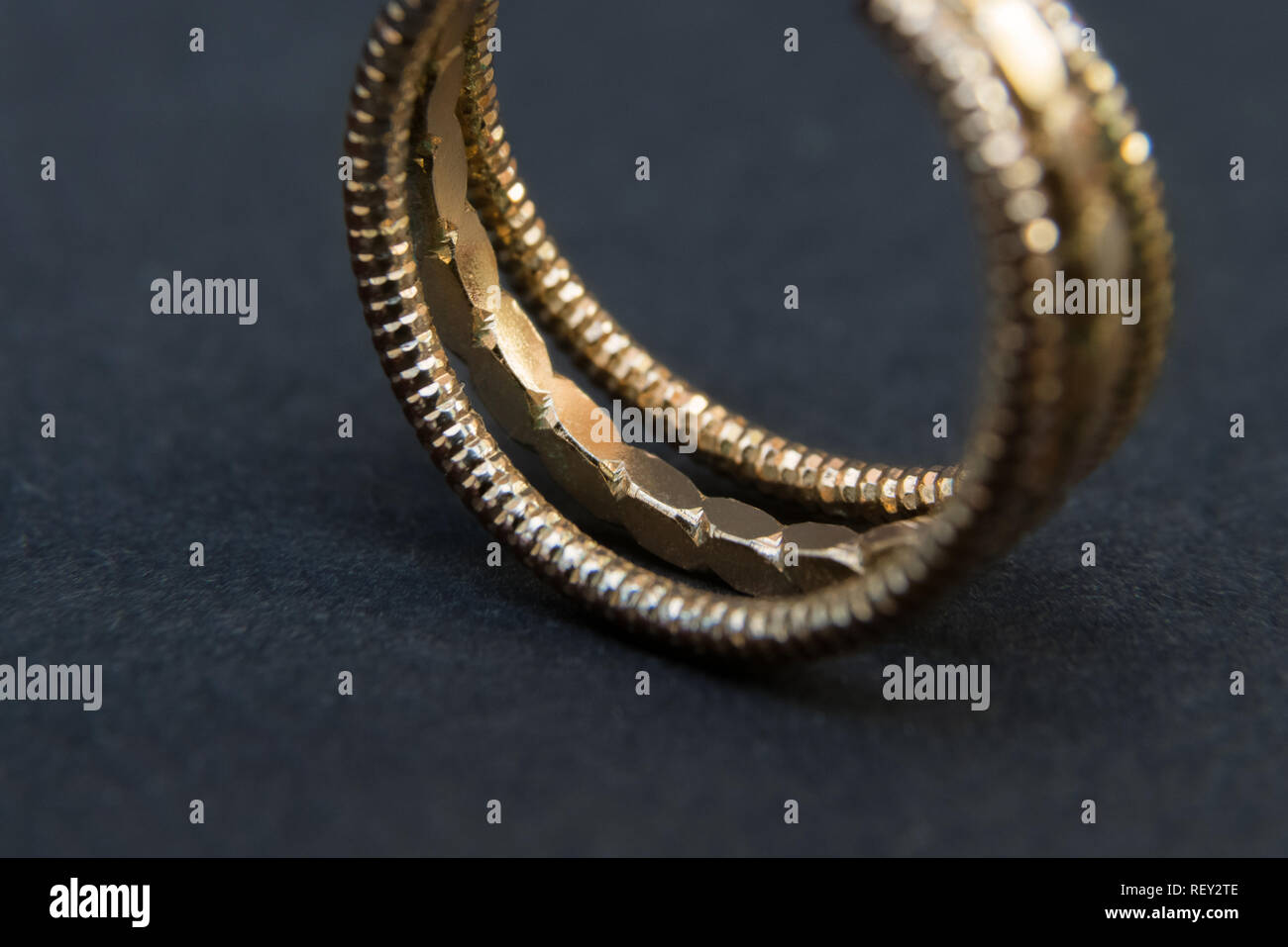Detail of golden wedding ring on black background Stock Photo - Alamy