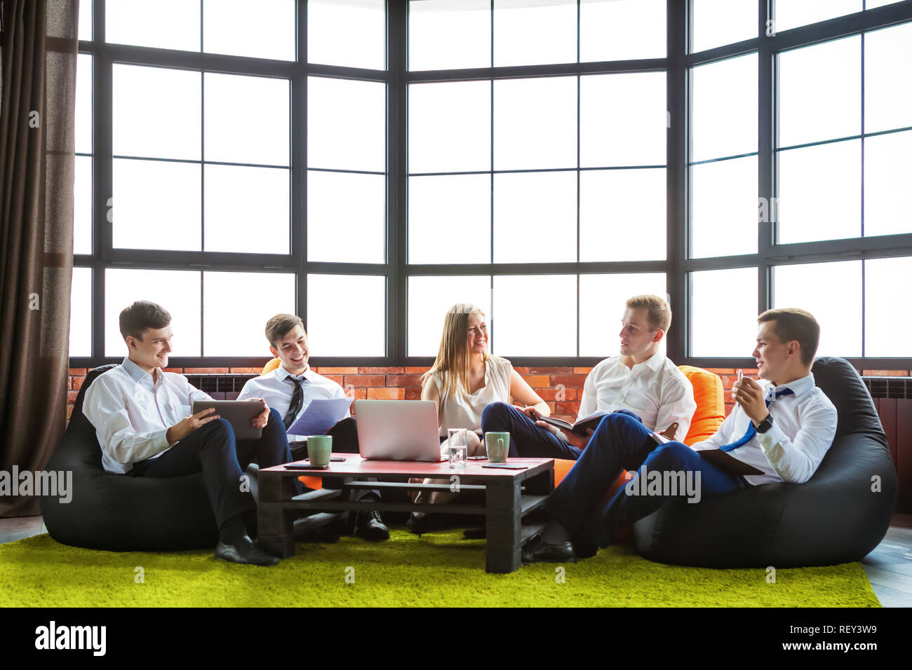 Group of business people sitting in an informal atmosphere Stock Photo ...