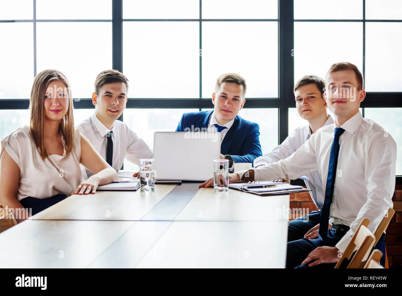 Group of young business people looking at camera Stock Photo - Alamy
