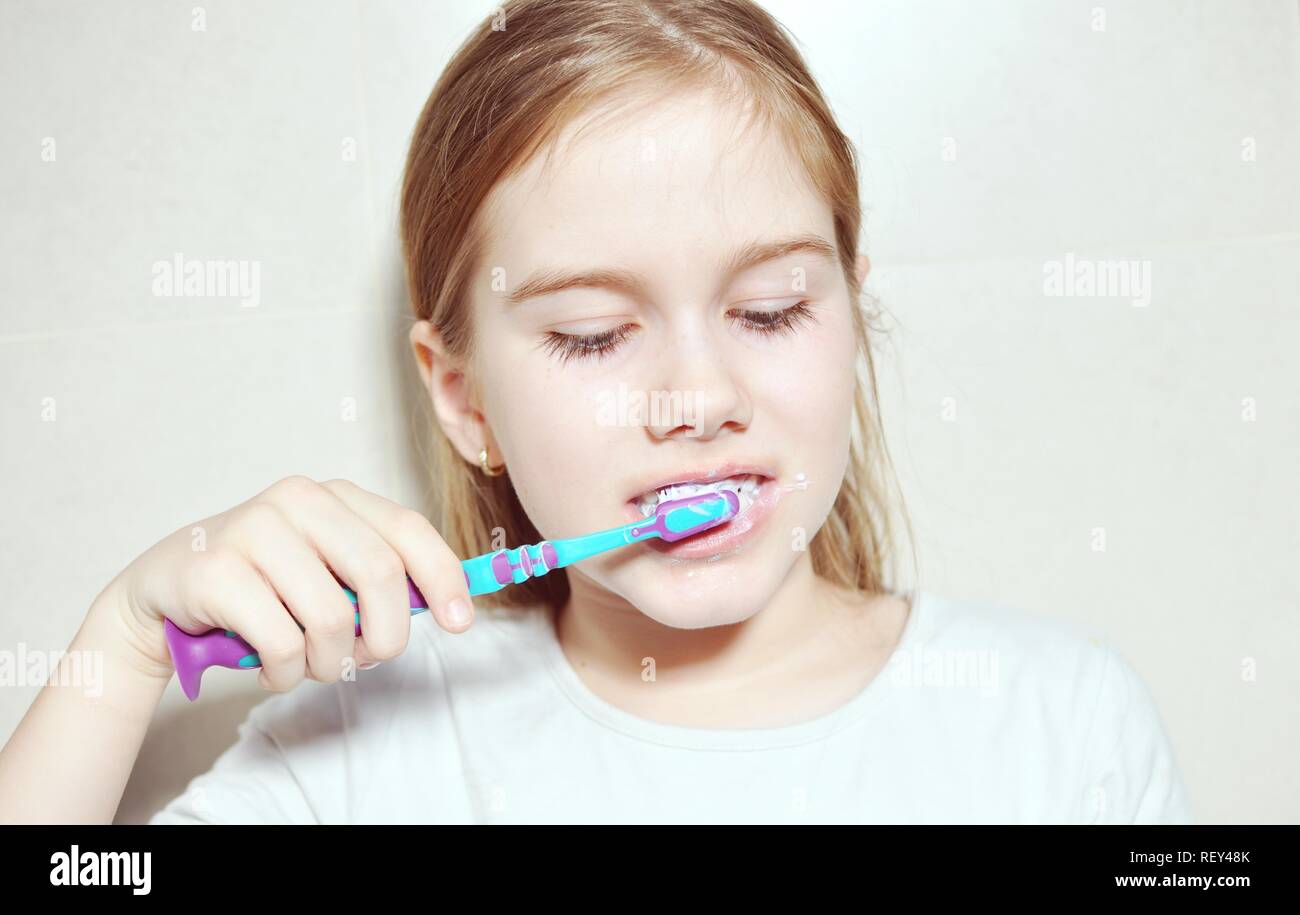 Close up of a child (kid) white European Caucasian girl washing the ...