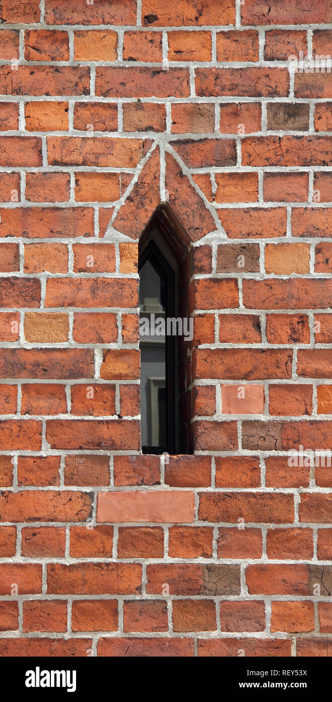 Narrow pointed window at a brick wall Stock Photo - Alamy