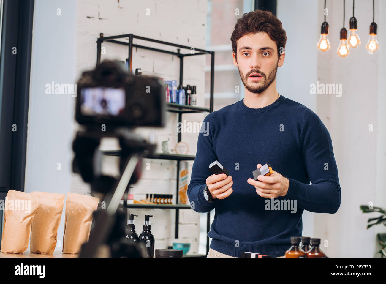 young male cosmetologist is creating a movie about cosmetics Stock ...