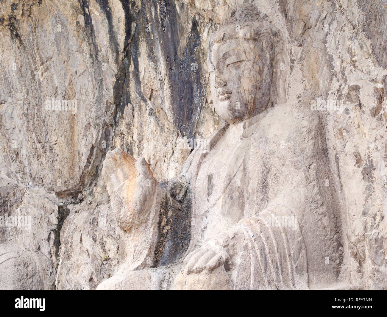 Luoyang Longmen grottoes. Broken Buddha and the stone caves and ...