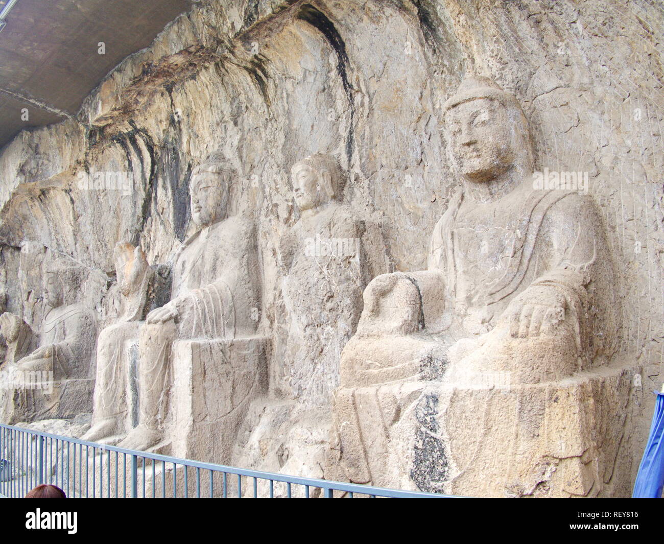 Luoyang Longmen grottoes. Broken Buddha and the stone caves and ...
