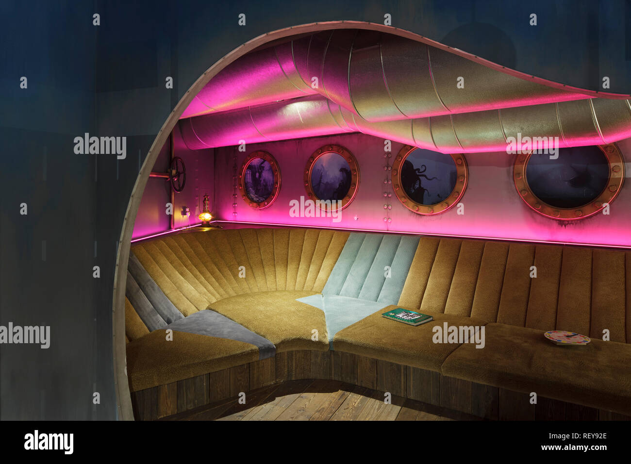 Submarine-themed seating area, with overhead portholes and pink ...