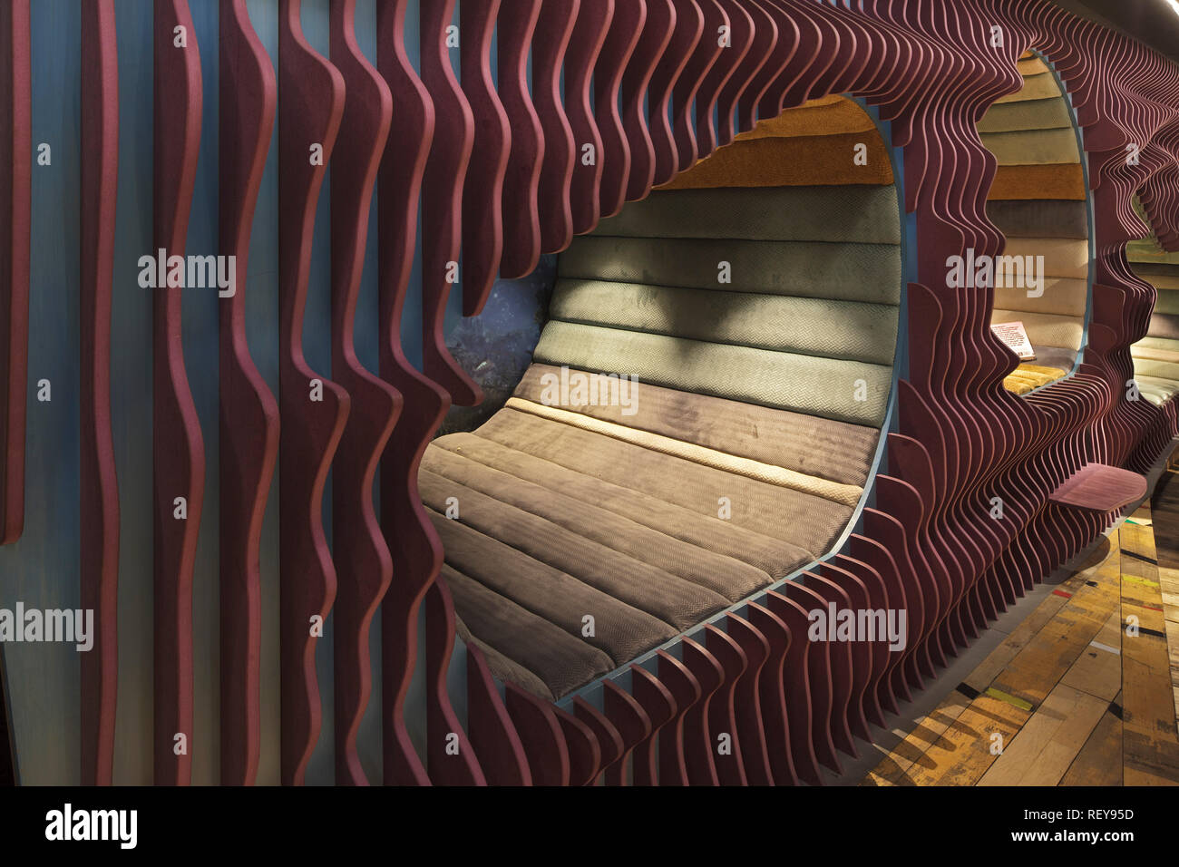 Undersea themed area with wavy blue and pink wall and seating cut-out ...