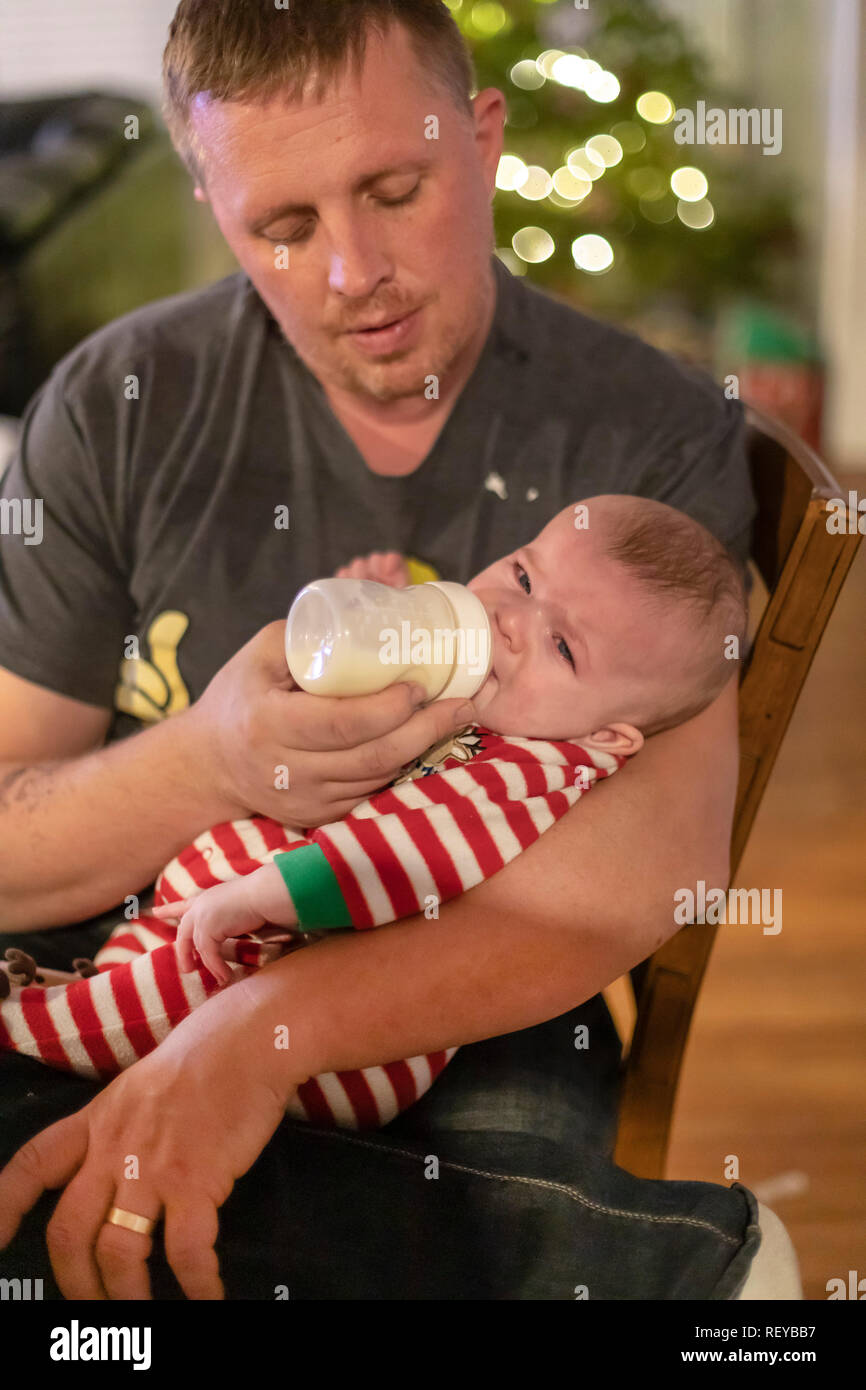 Denver, Colorado - Adam Hjermstad Sr. feeds his four-month-old son ...
