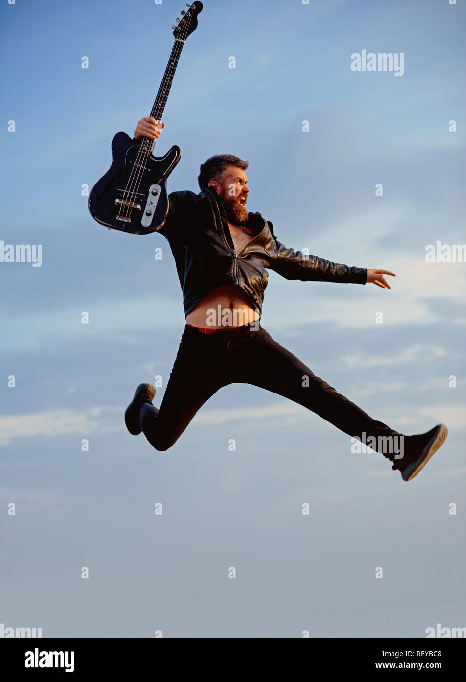Motion and fun concept. Happy young man jumping in air and playing ...