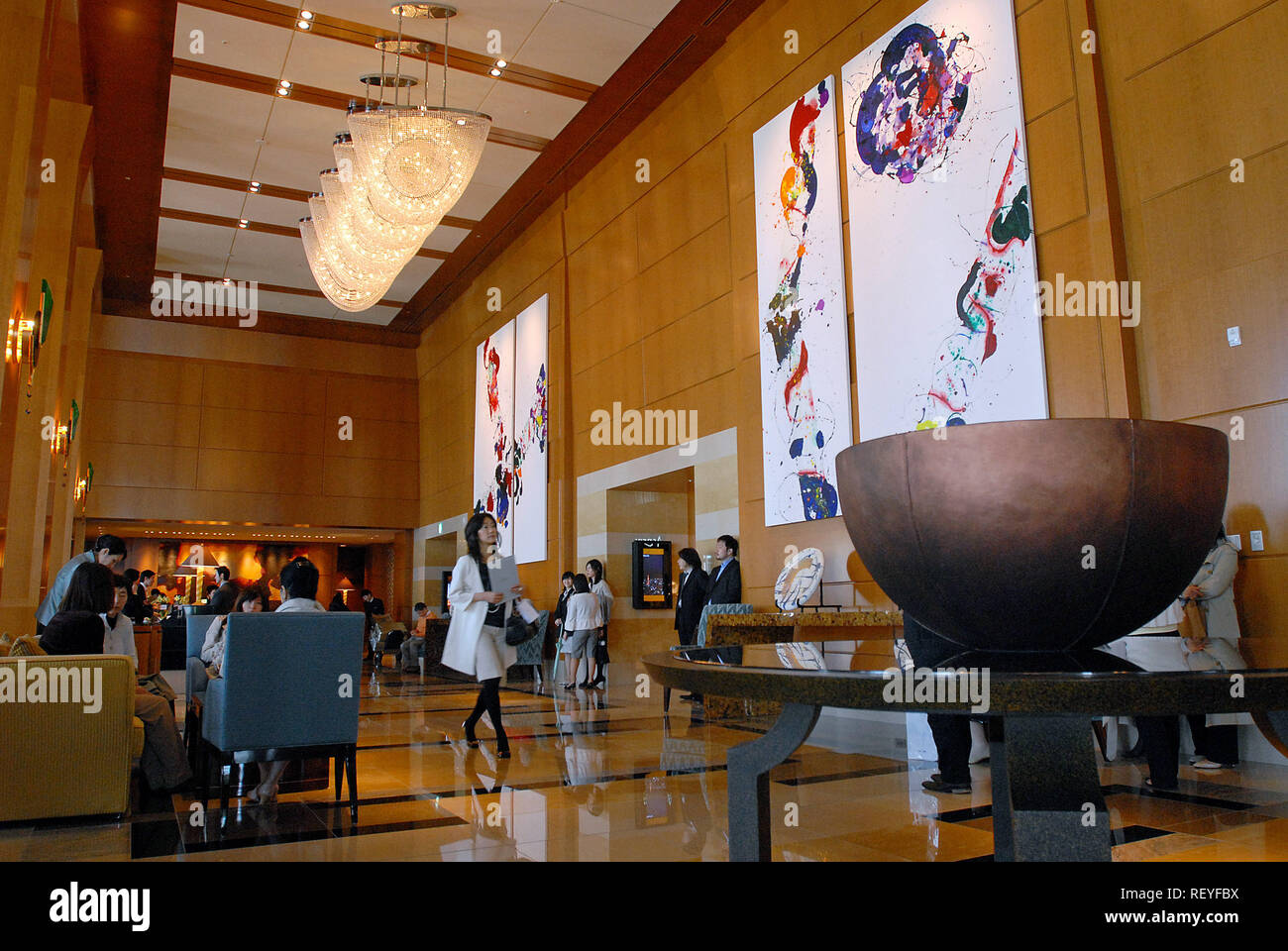 Guests check in at the reception of the Ritz Carlton Hotel, which ...