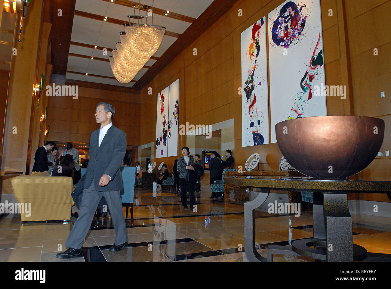 Guests check in at the reception of the Ritz Carlton Hotel, which ...