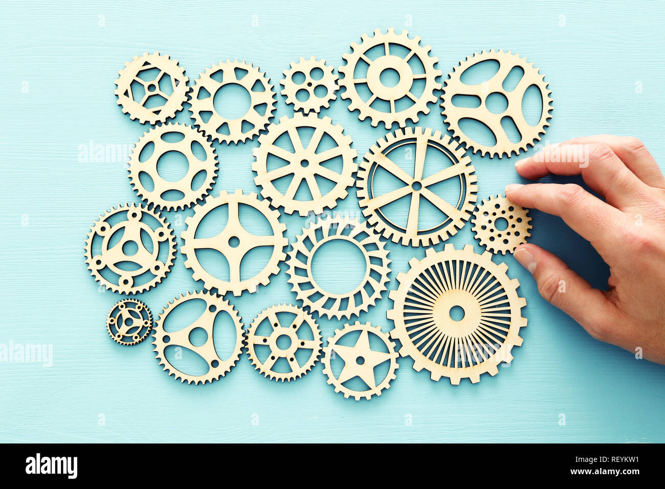 hand placing a cogwheel in set of gears mechanism Stock Photo - Alamy