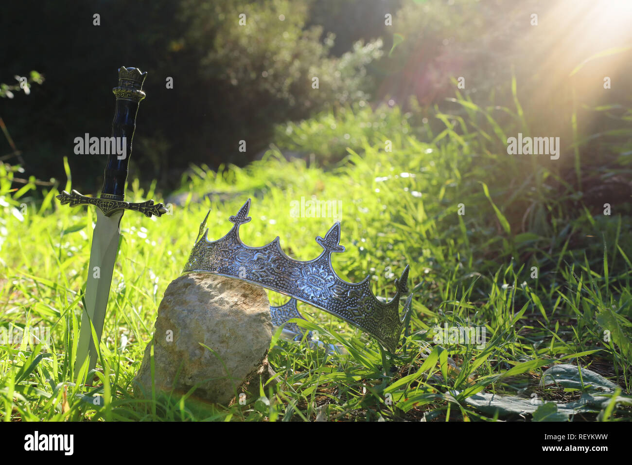 mysterious and magical photo of silver king crown and sword over the ...