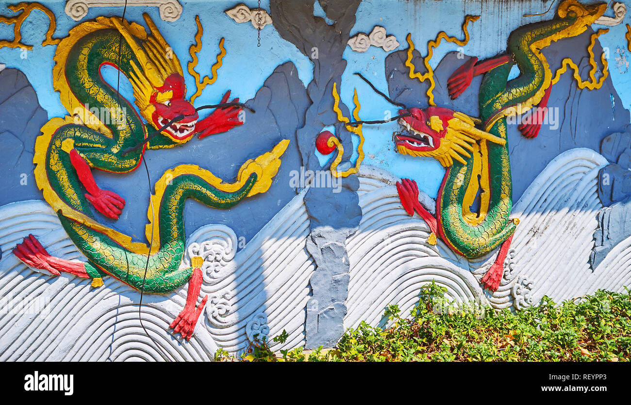 YANGON, MYANMAR - FEBRUARY 17, 2018: The old dragon relief on the wall ...