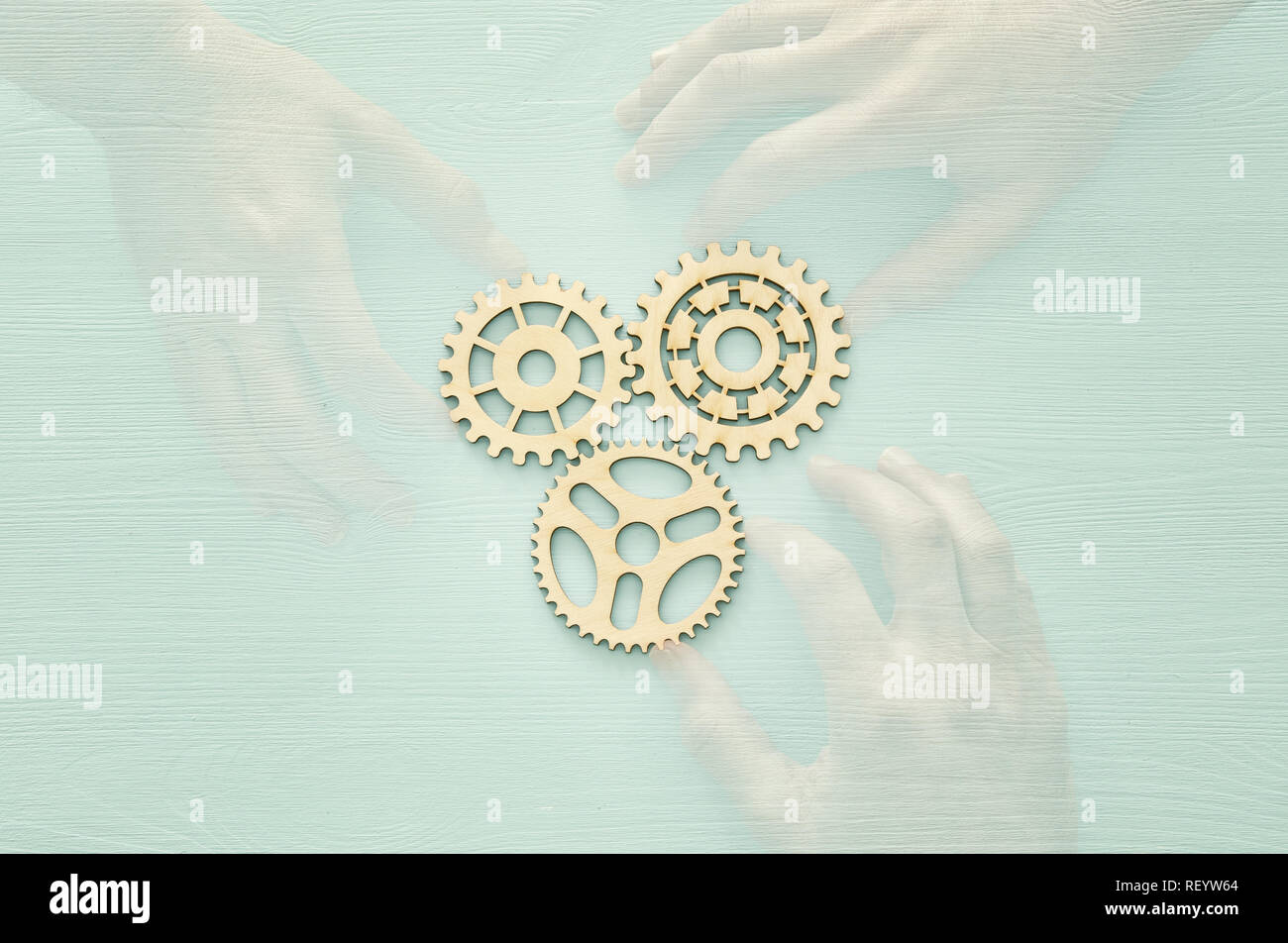 hand placing a cogwheel in set of gears mechanism Stock Photo - Alamy