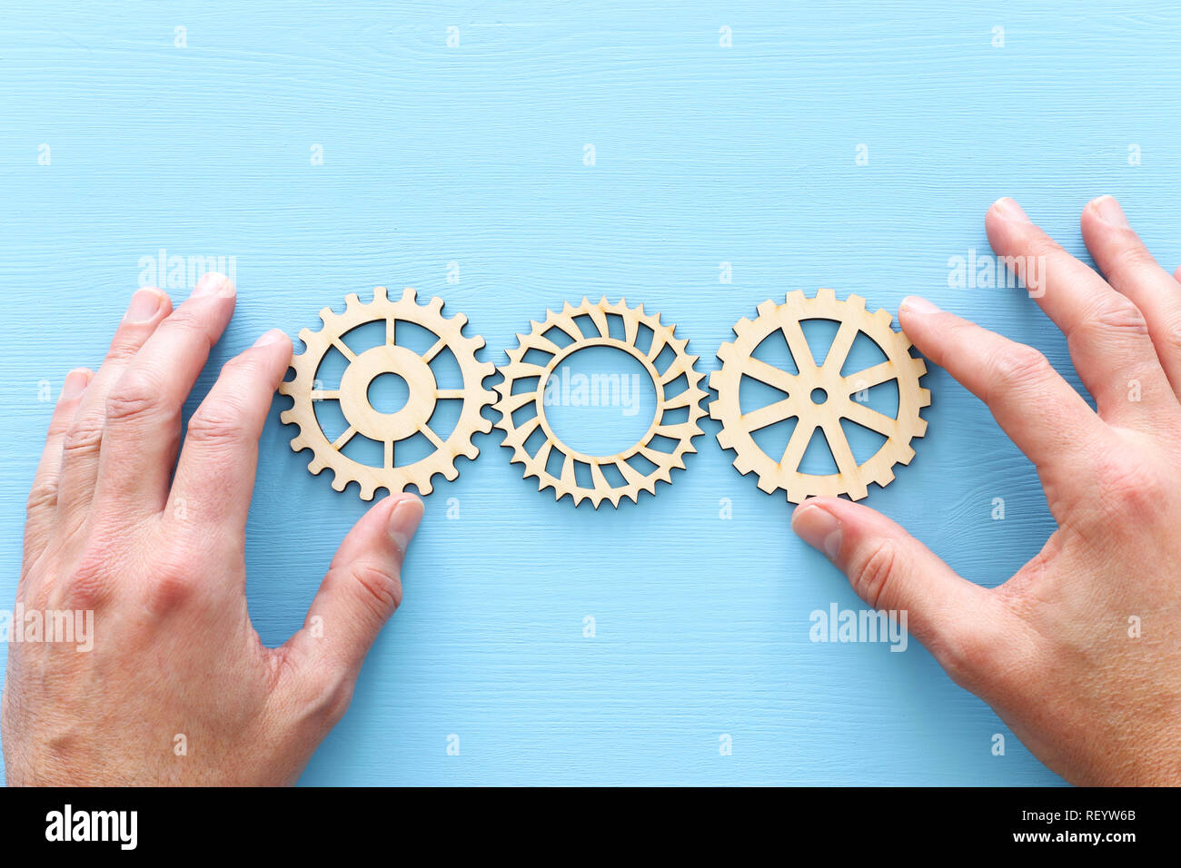 hand placing a cogwheel in set of gears mechanism Stock Photo - Alamy