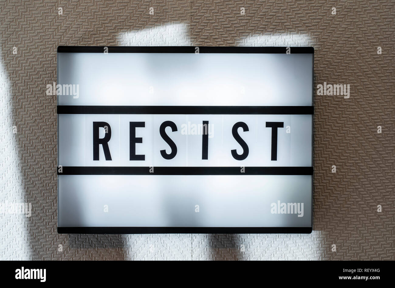 Message Resist on illuminated board. Opposition concept with text ...