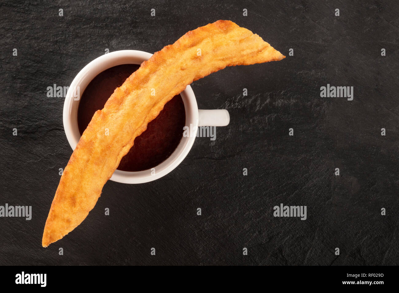 A photo of traditional Spanish porras with hot chocolate, a typical ...